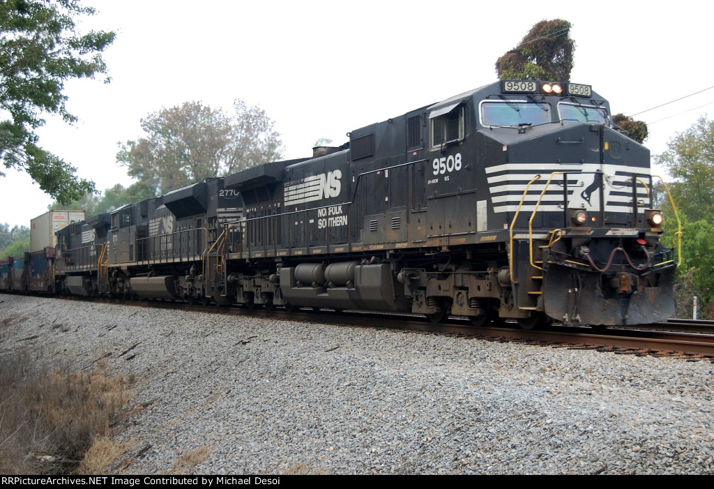 NS C40-9W #9508 is about to cross Walters Highwya with an eastbound stack train.